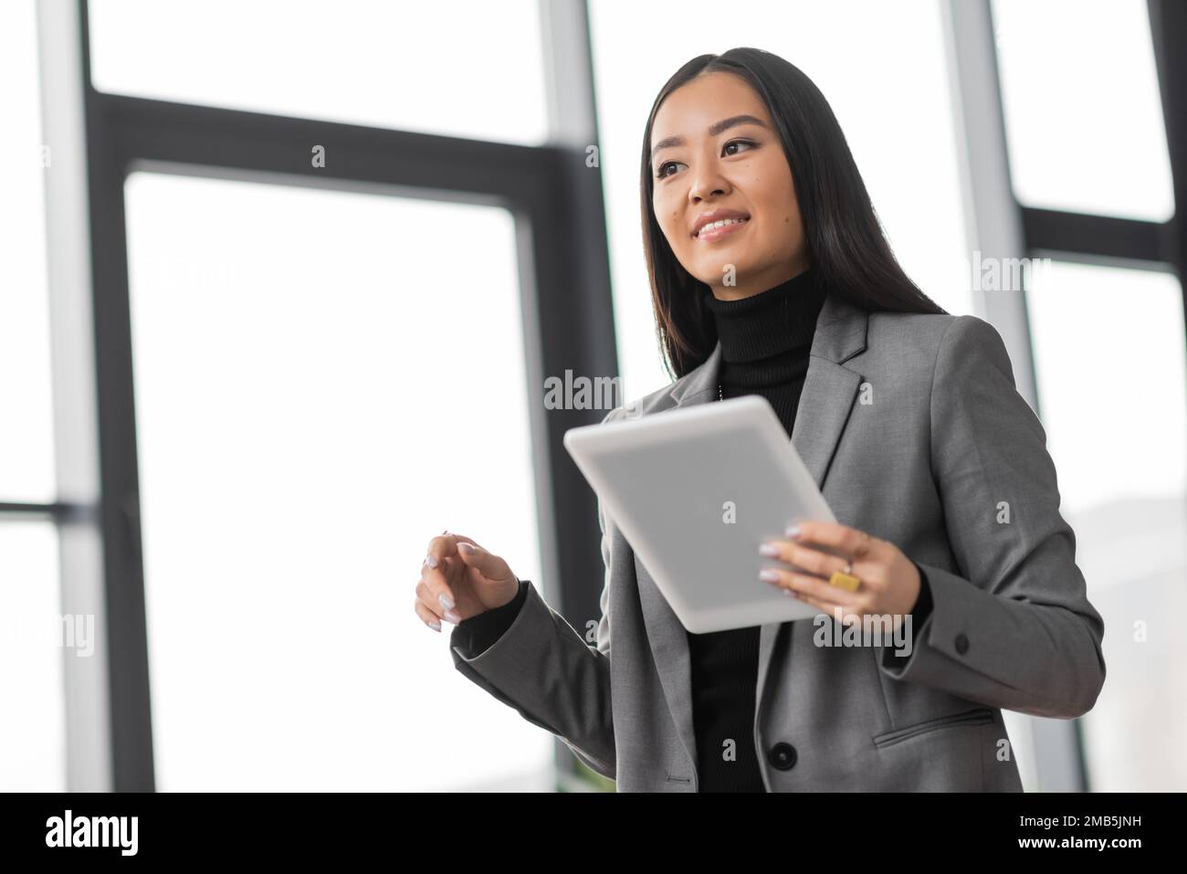 Smiling asian interior designer holding digital tablet in office,stock ...