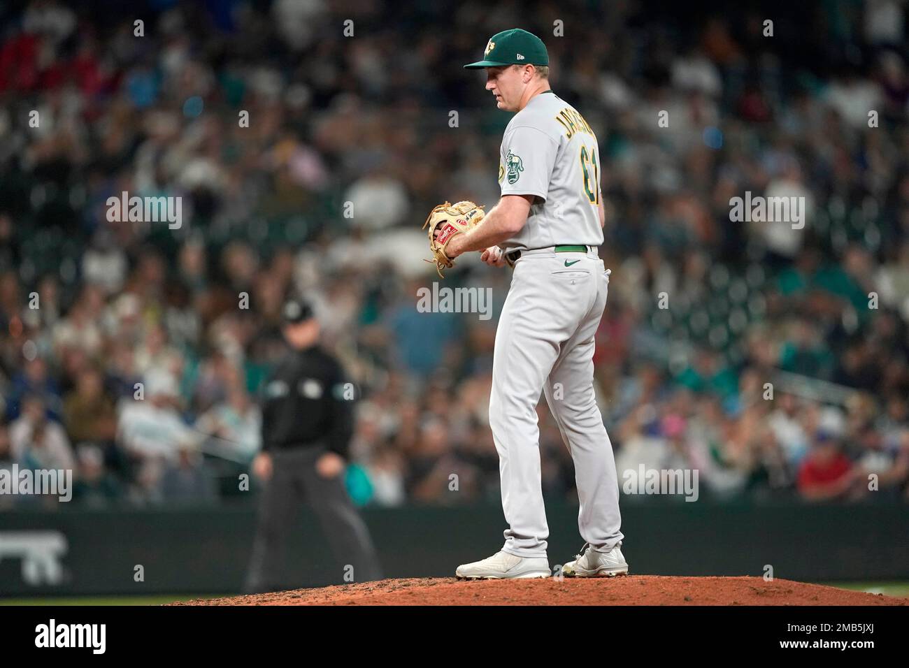 Oakland Athletics relief pitcher Zach Jackson looks for a sign with the ...