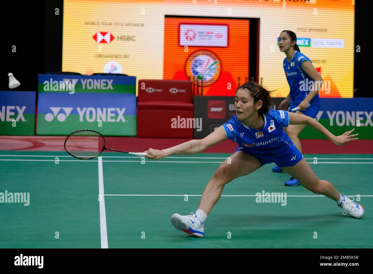 Japan's Rin Iwanaga, front, and Kie Nakanishi, play against Malaysia's ...