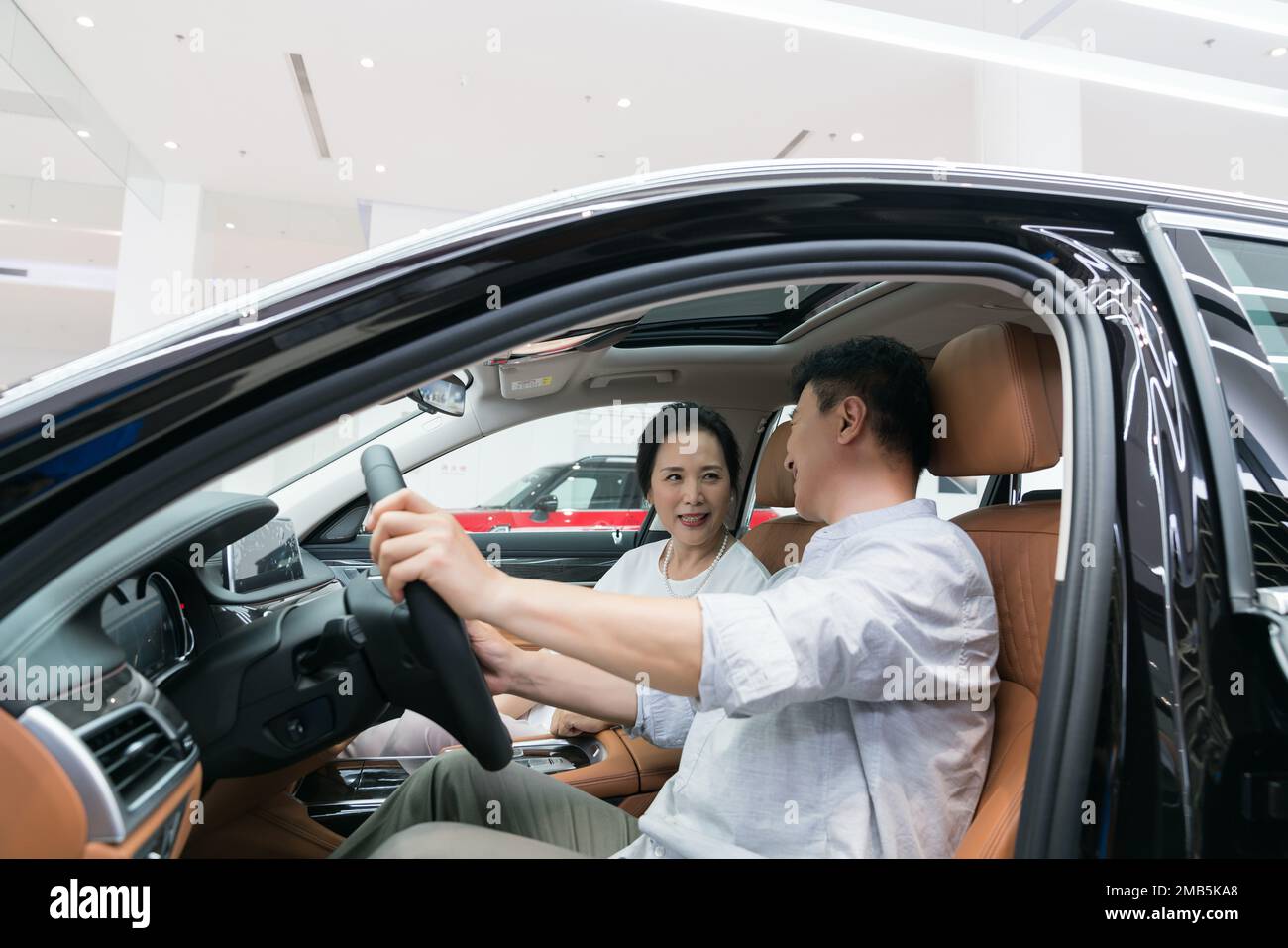 Elderly couples test drive cars Stock Photo - Alamy