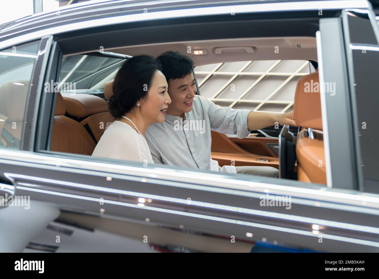 Elderly couples test drive cars Stock Photo - Alamy