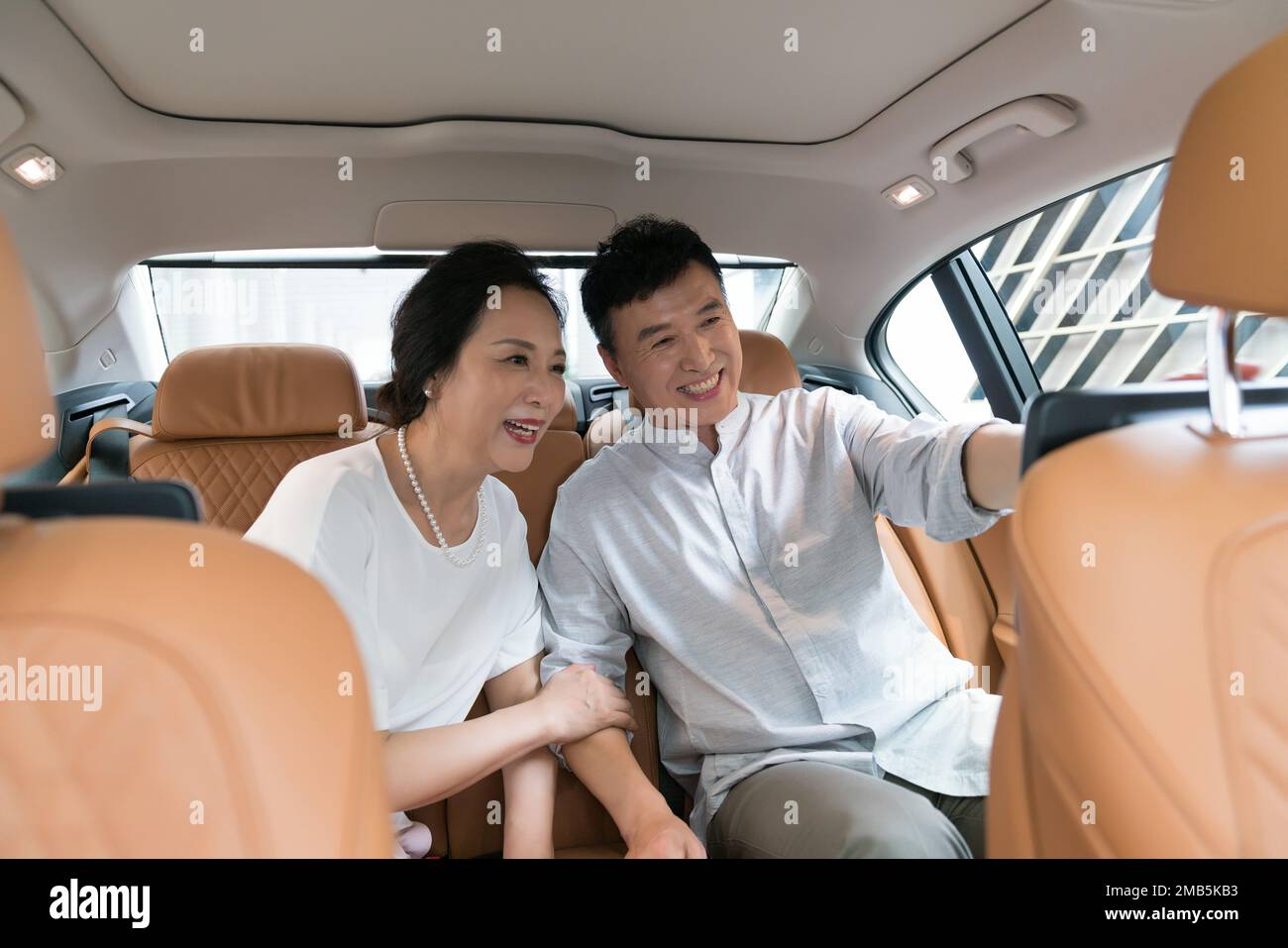 Elderly couples test drive cars Stock Photo - Alamy