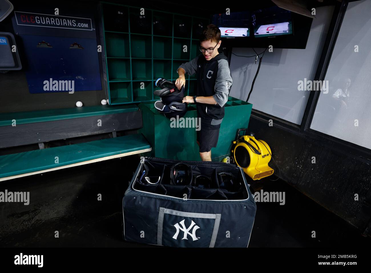 Clubhouse attendant Tyler Danburg packs the New York Yankees' helmets ...