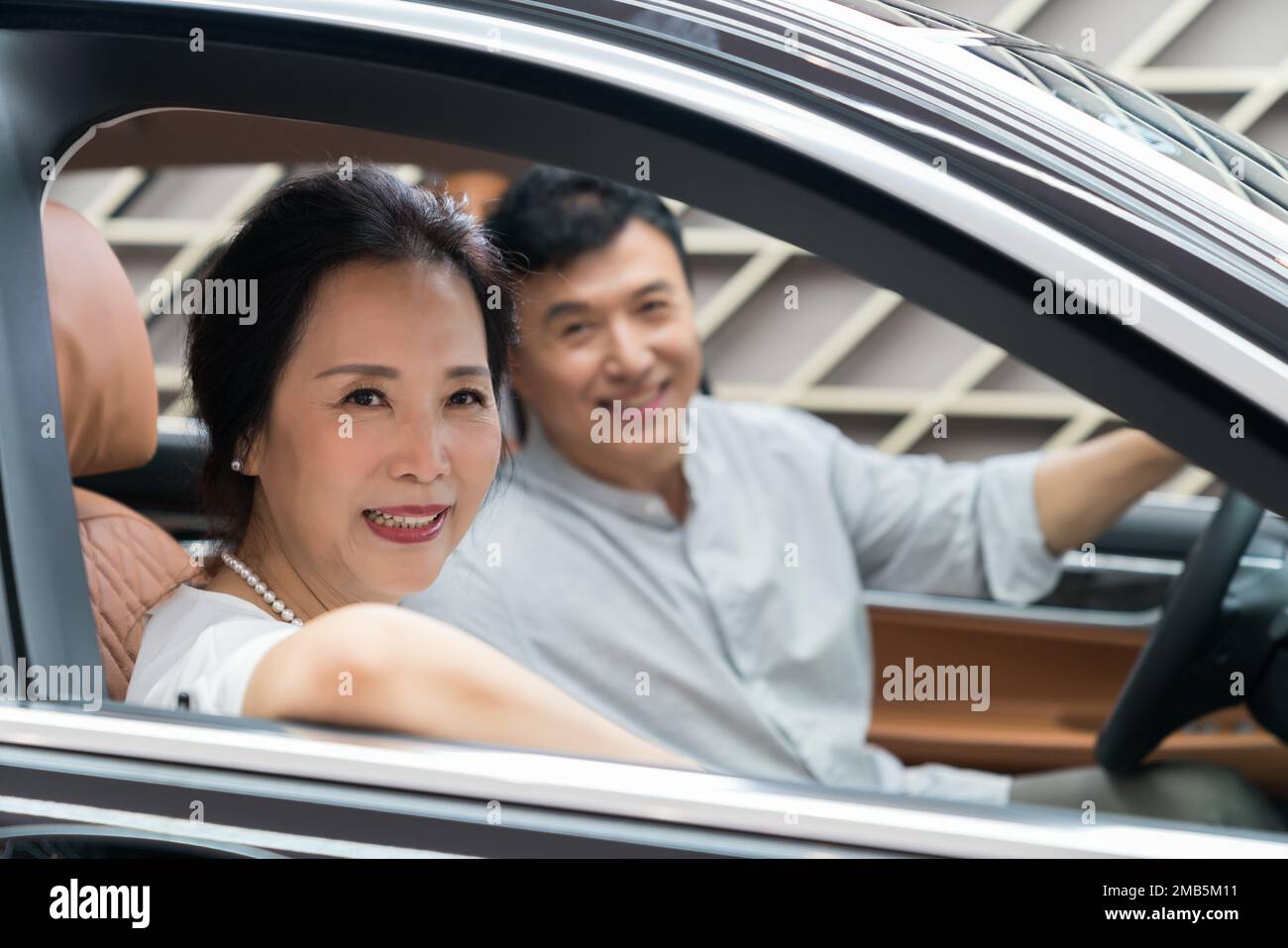 Elderly couples test drive cars Stock Photo - Alamy
