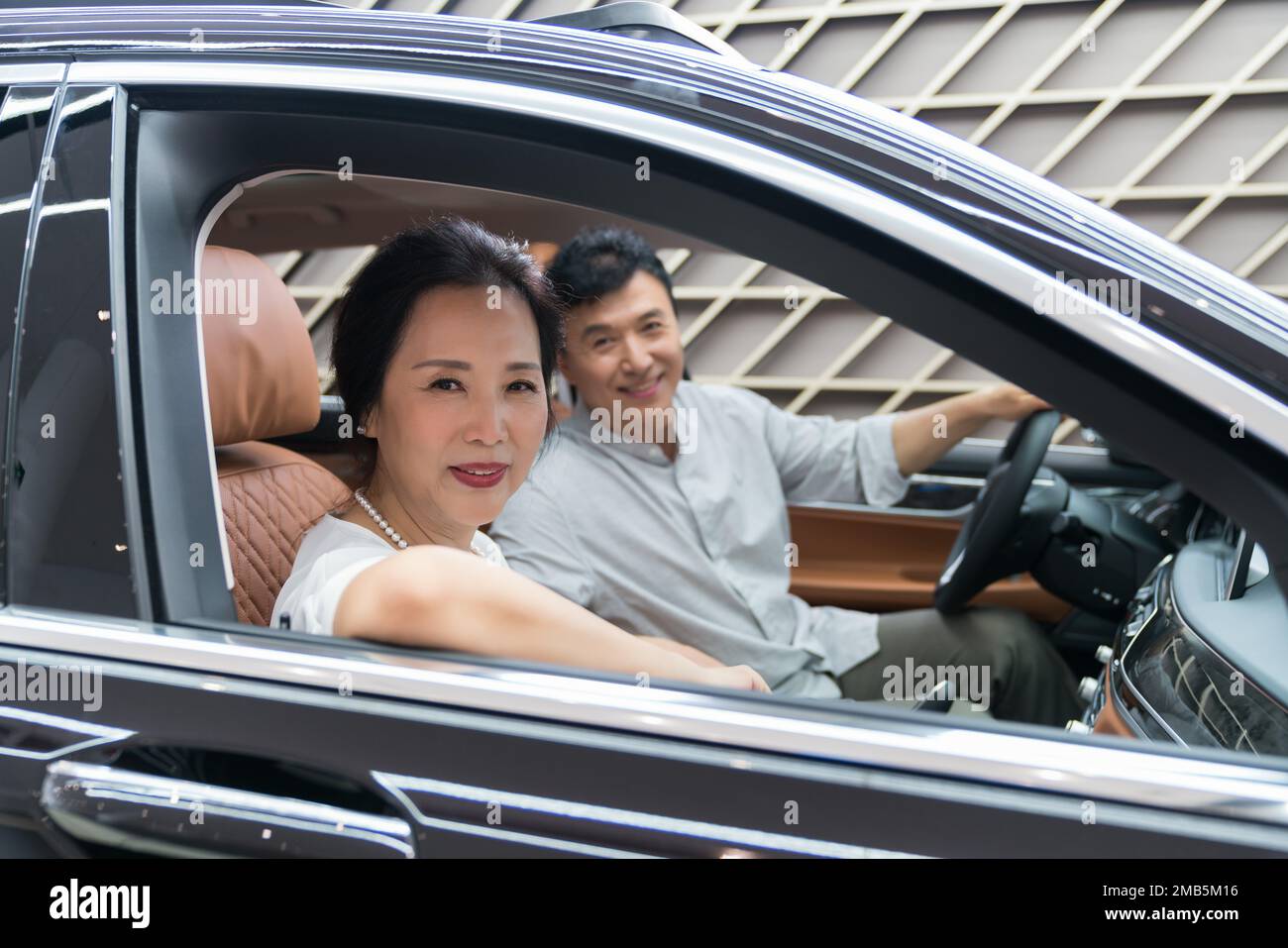 Elderly couples test drive cars Stock Photo - Alamy