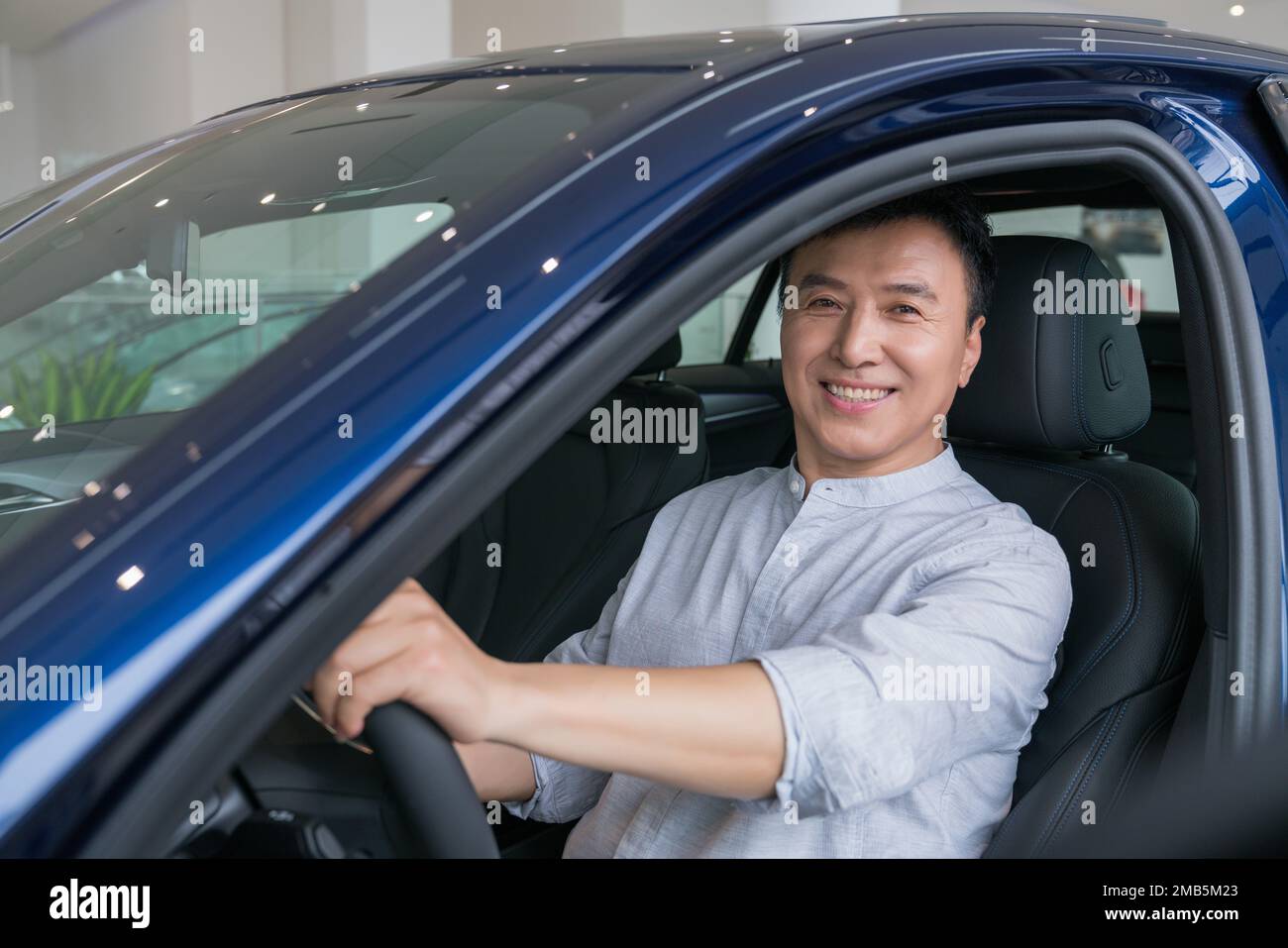 The old man test drive car Stock Photo - Alamy