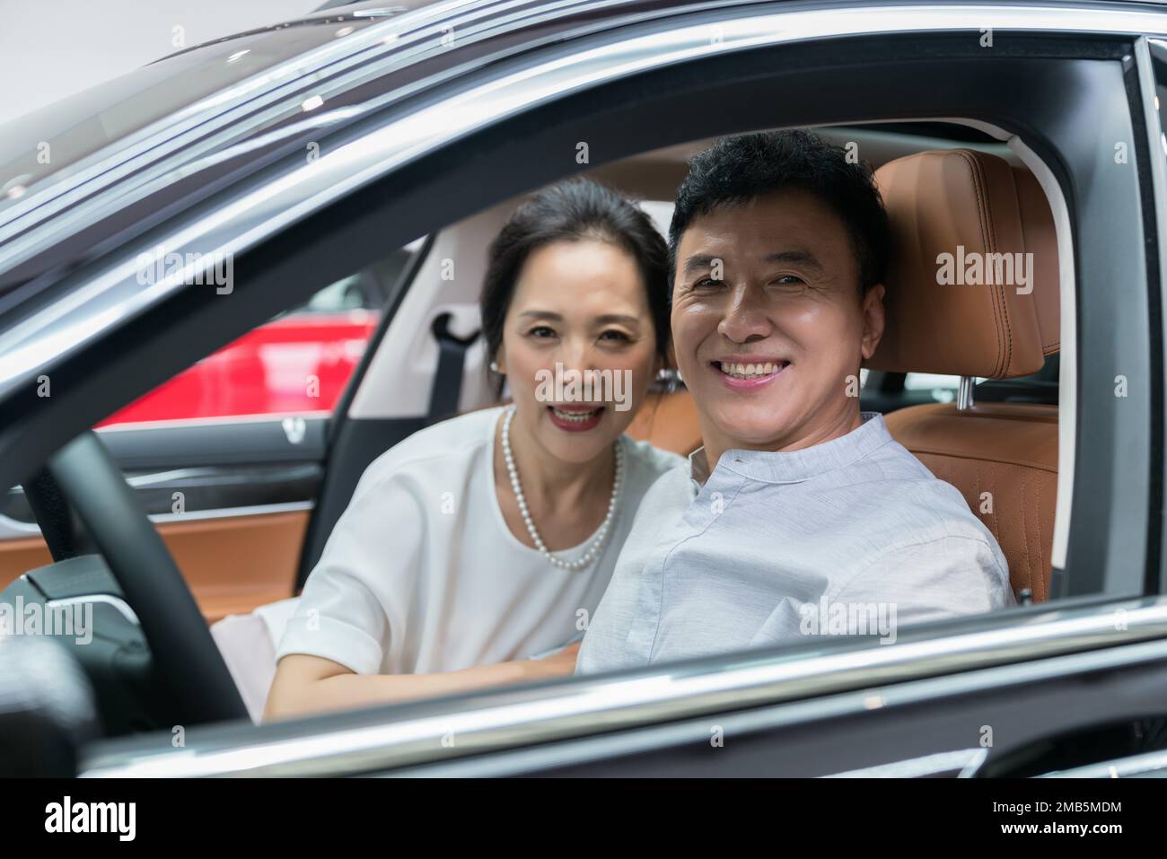 Elderly couples test drive cars Stock Photo - Alamy
