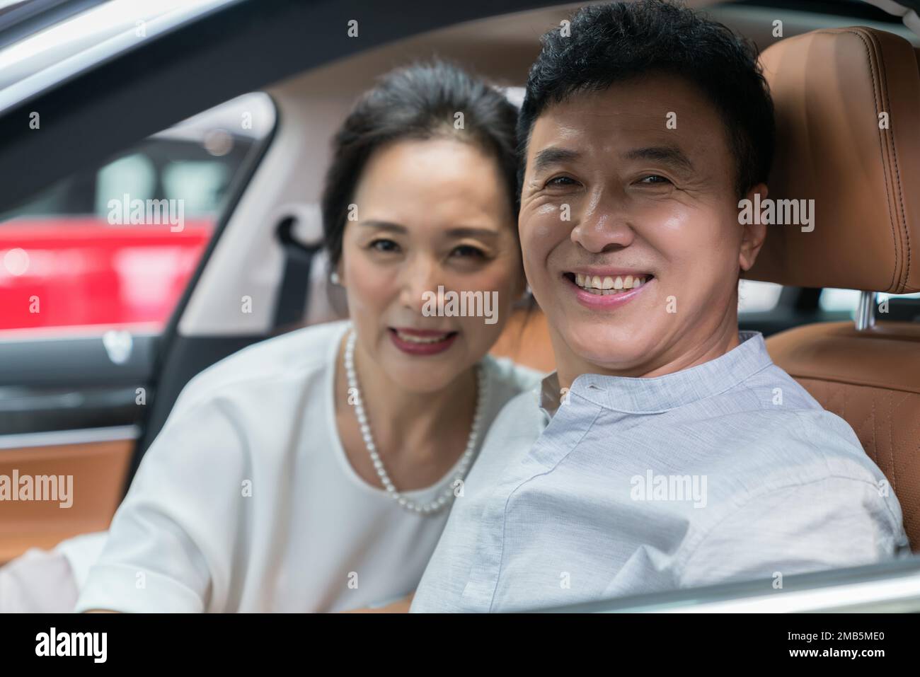 Elderly couples test drive cars Stock Photo - Alamy