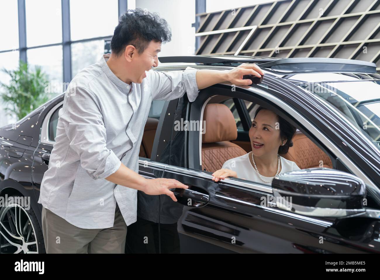 Elderly couples test drive cars Stock Photo - Alamy