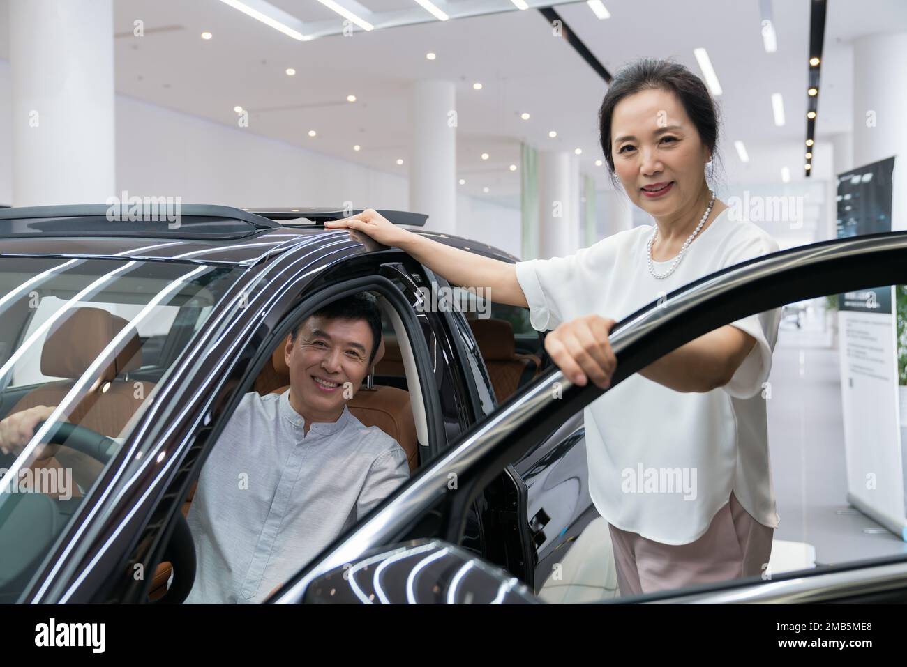Elderly couples test drive cars Stock Photo - Alamy
