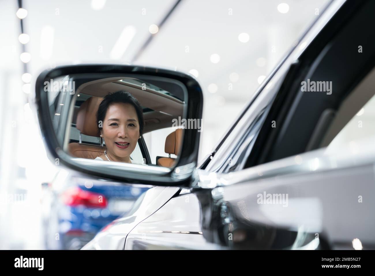Elderly woman test drive cars Stock Photo - Alamy