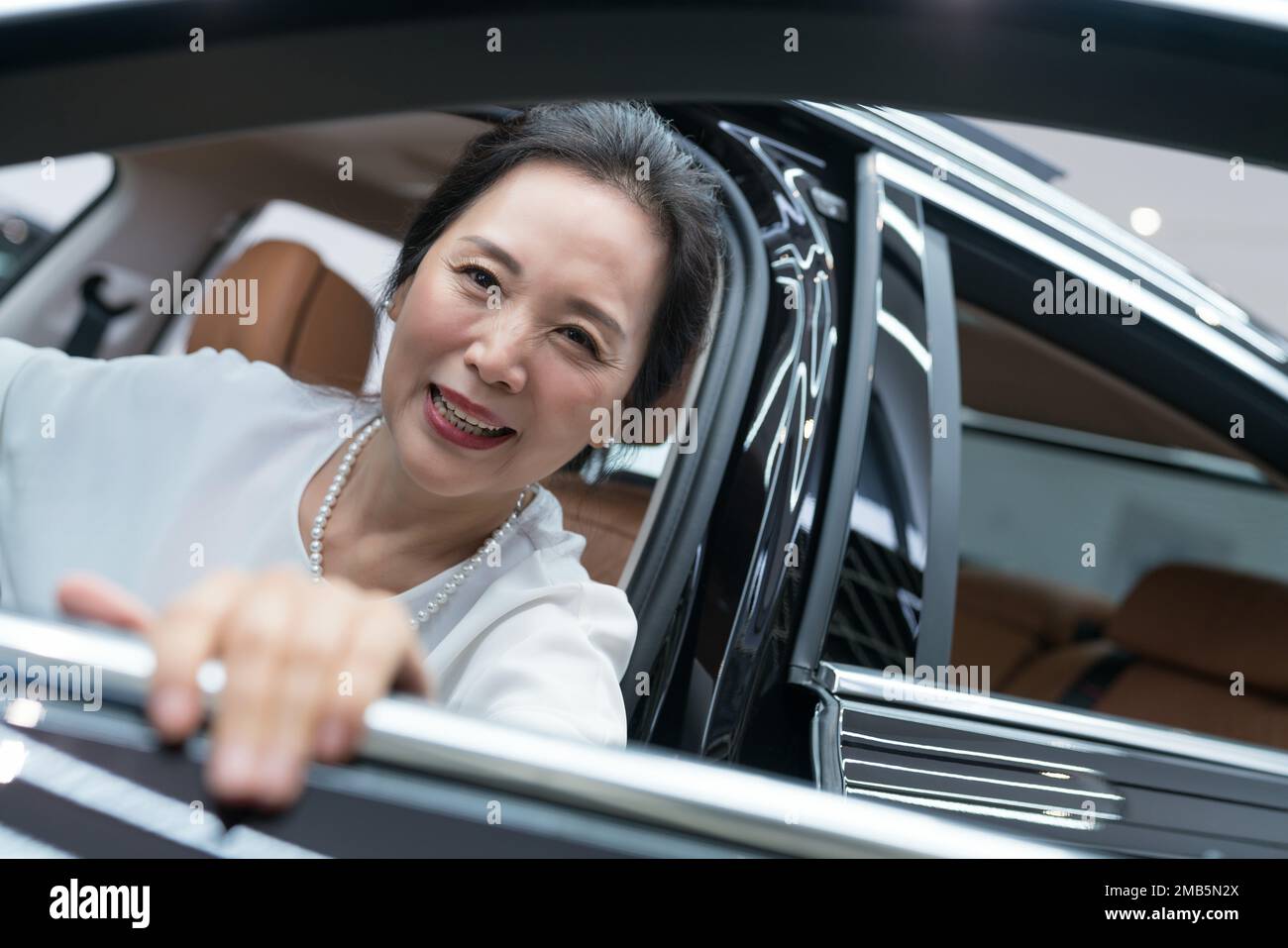 Elderly woman test drive cars Stock Photo - Alamy