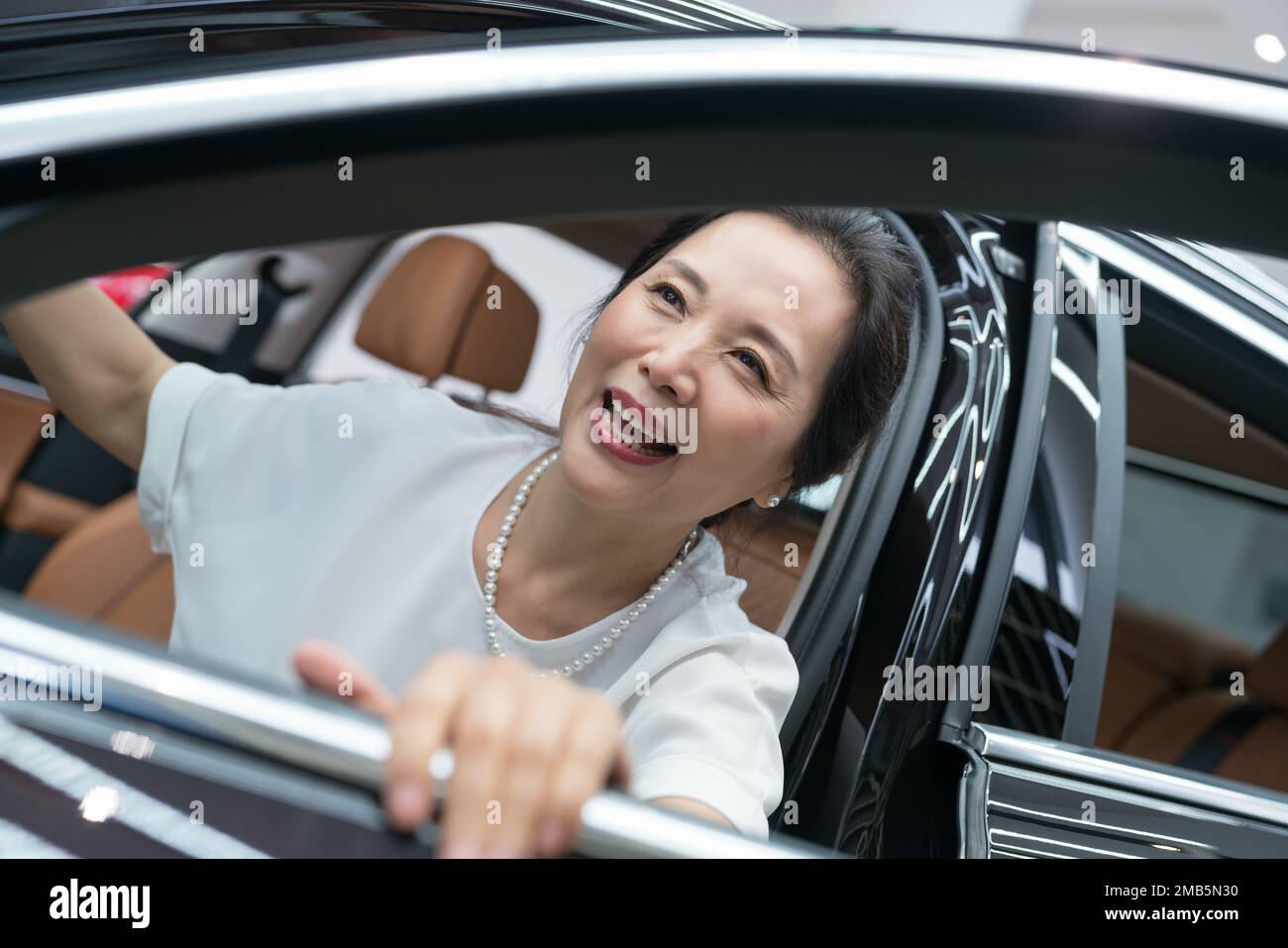 Elderly woman test drive cars Stock Photo - Alamy
