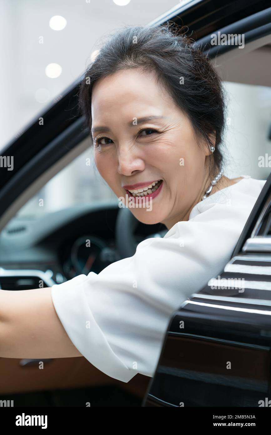Elderly woman test drive cars Stock Photo - Alamy