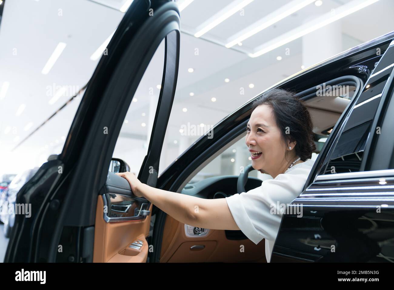 Elderly woman test drive cars Stock Photo - Alamy