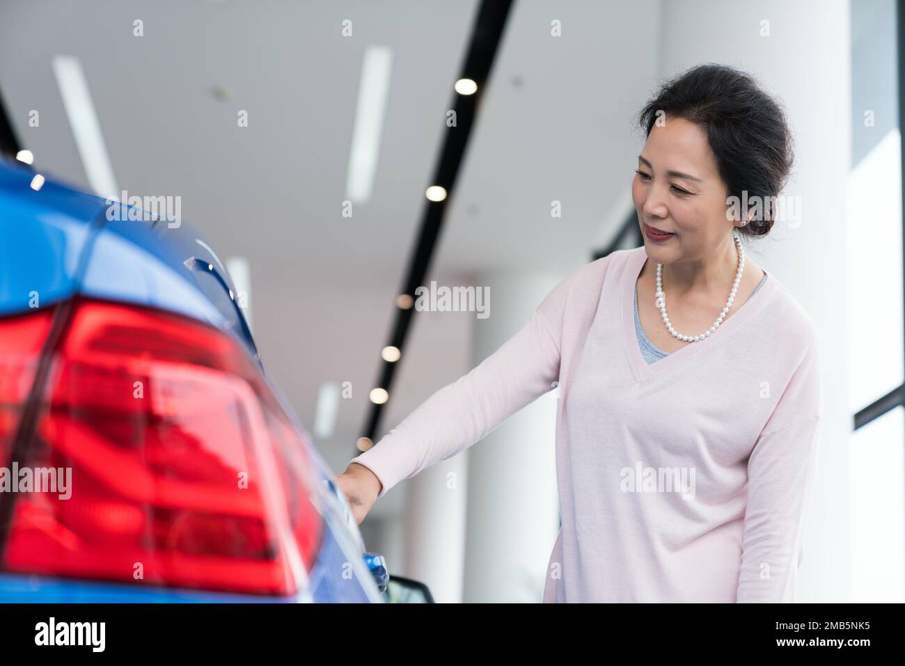 Older women choose and buy cars Stock Photo - Alamy