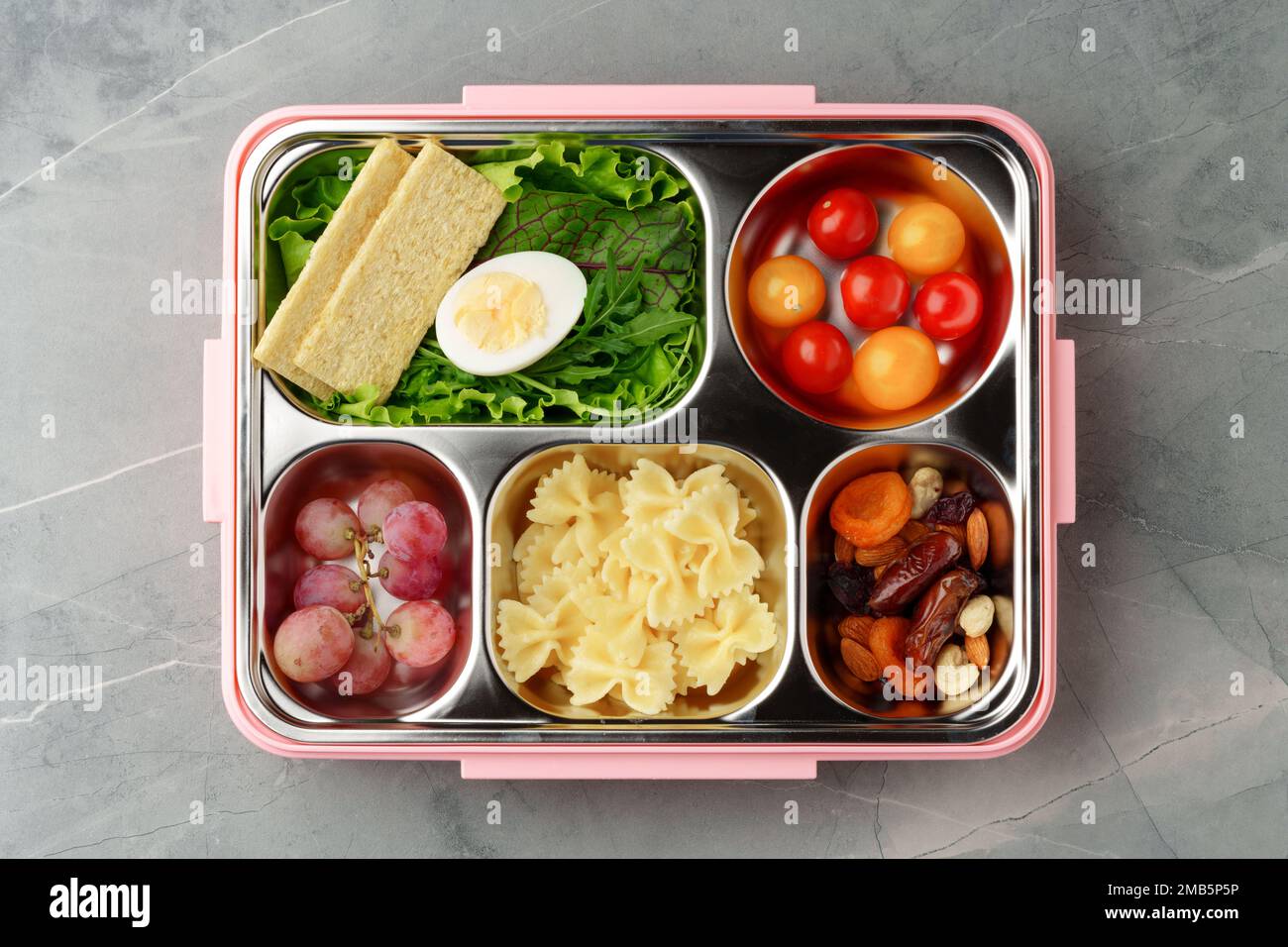 Lunch box with ready food on gray background Stock Photo - Alamy