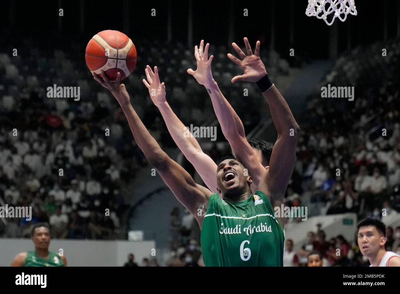 Saudi Arabia's Mathna Almarwani battles for the ball against Indonesia ...