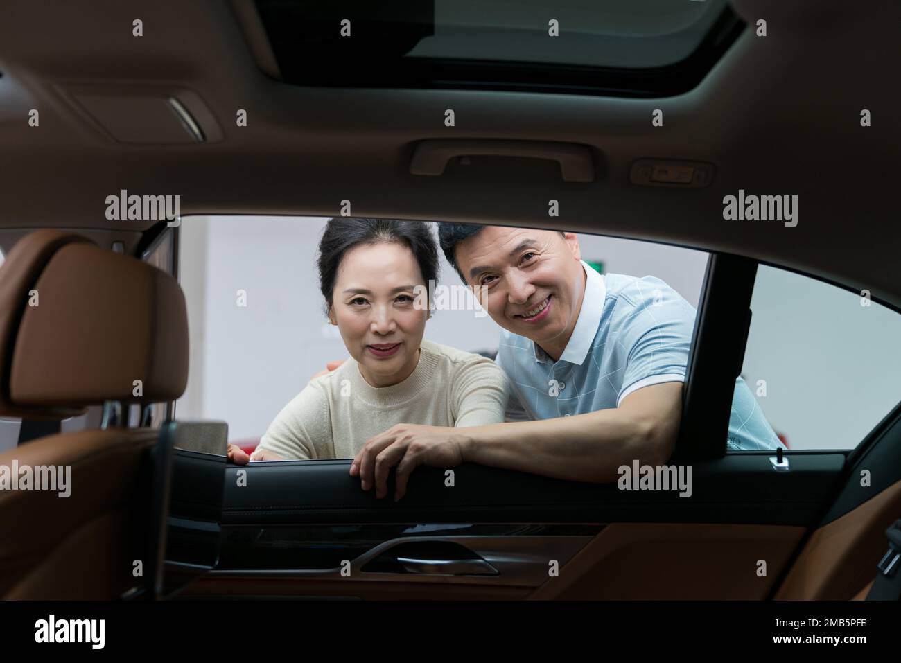 Elderly couples test drive cars Stock Photo - Alamy