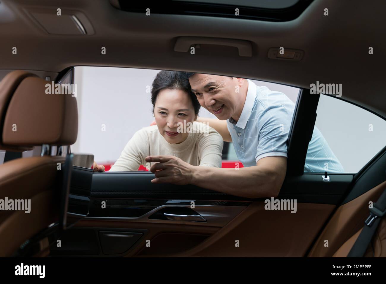 Elderly couples test drive cars Stock Photo - Alamy