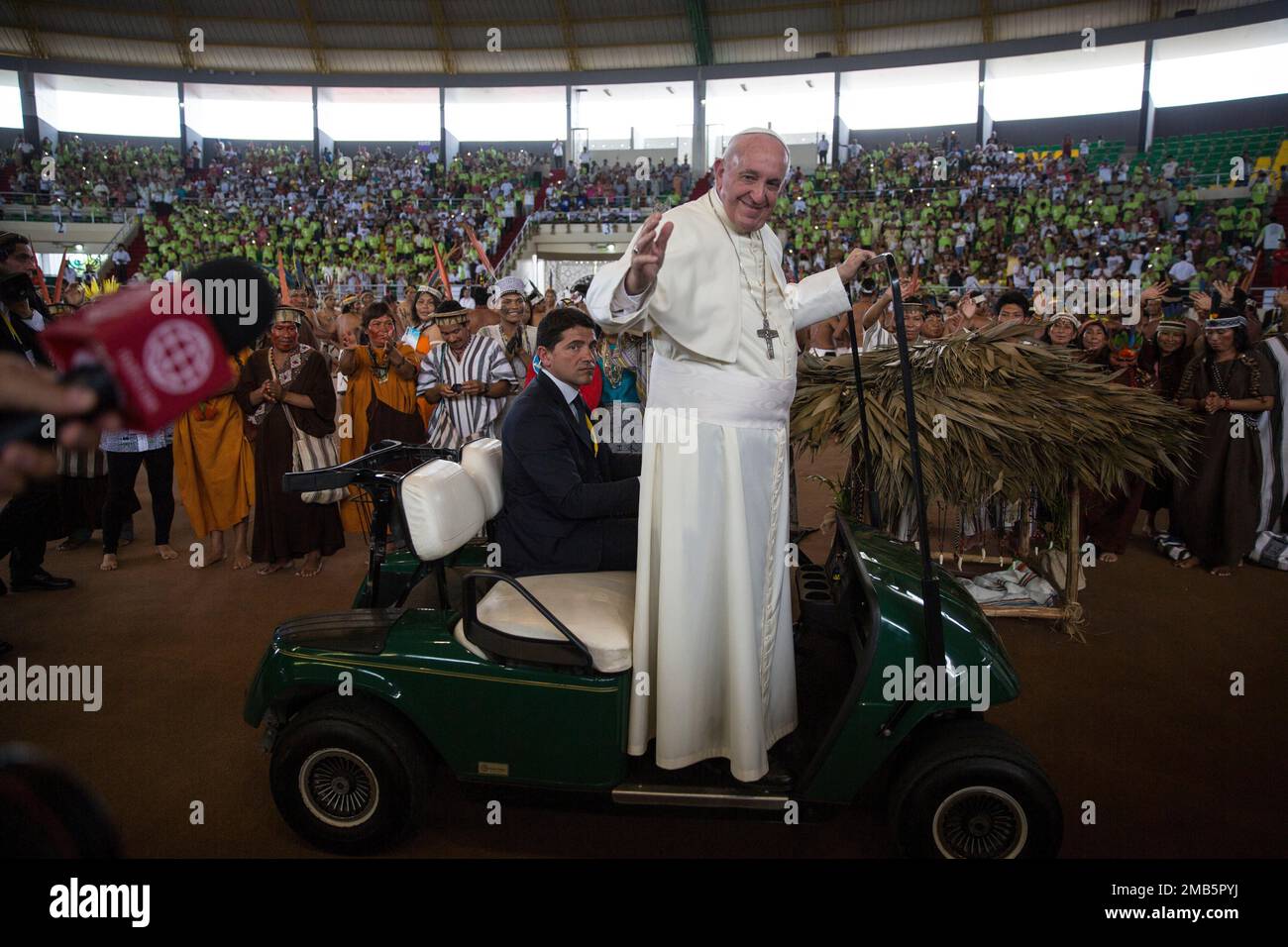FILE - Pope Francis waves from a golf cart as he is driven inside a ...