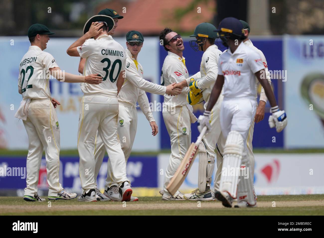 Australia's team members congratulate bowler Travis Head, without cap ...