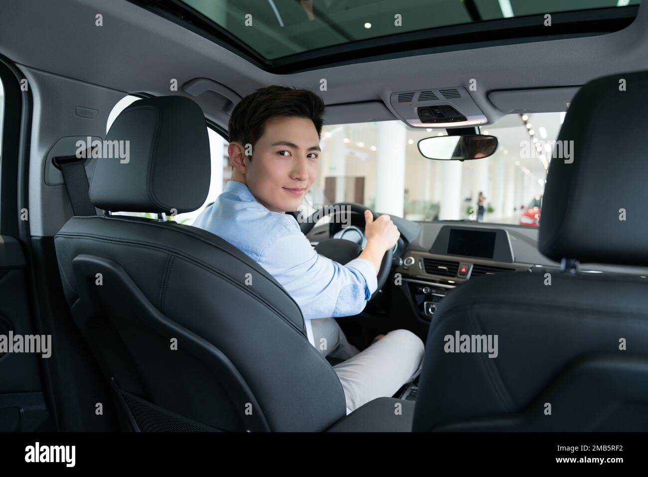 A young business man driving Stock Photo - Alamy