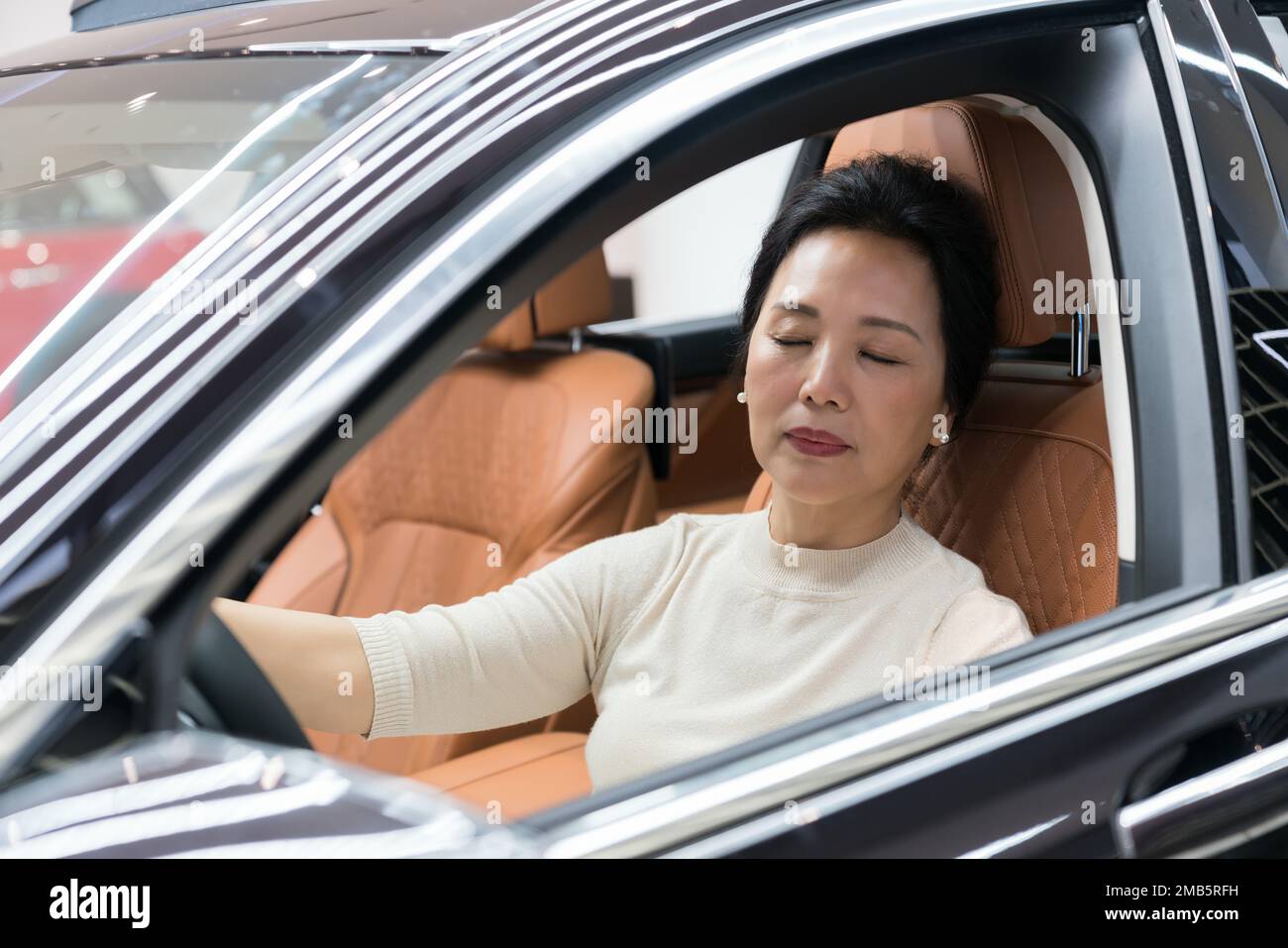 Business lady sat in the car to rest Stock Photo - Alamy