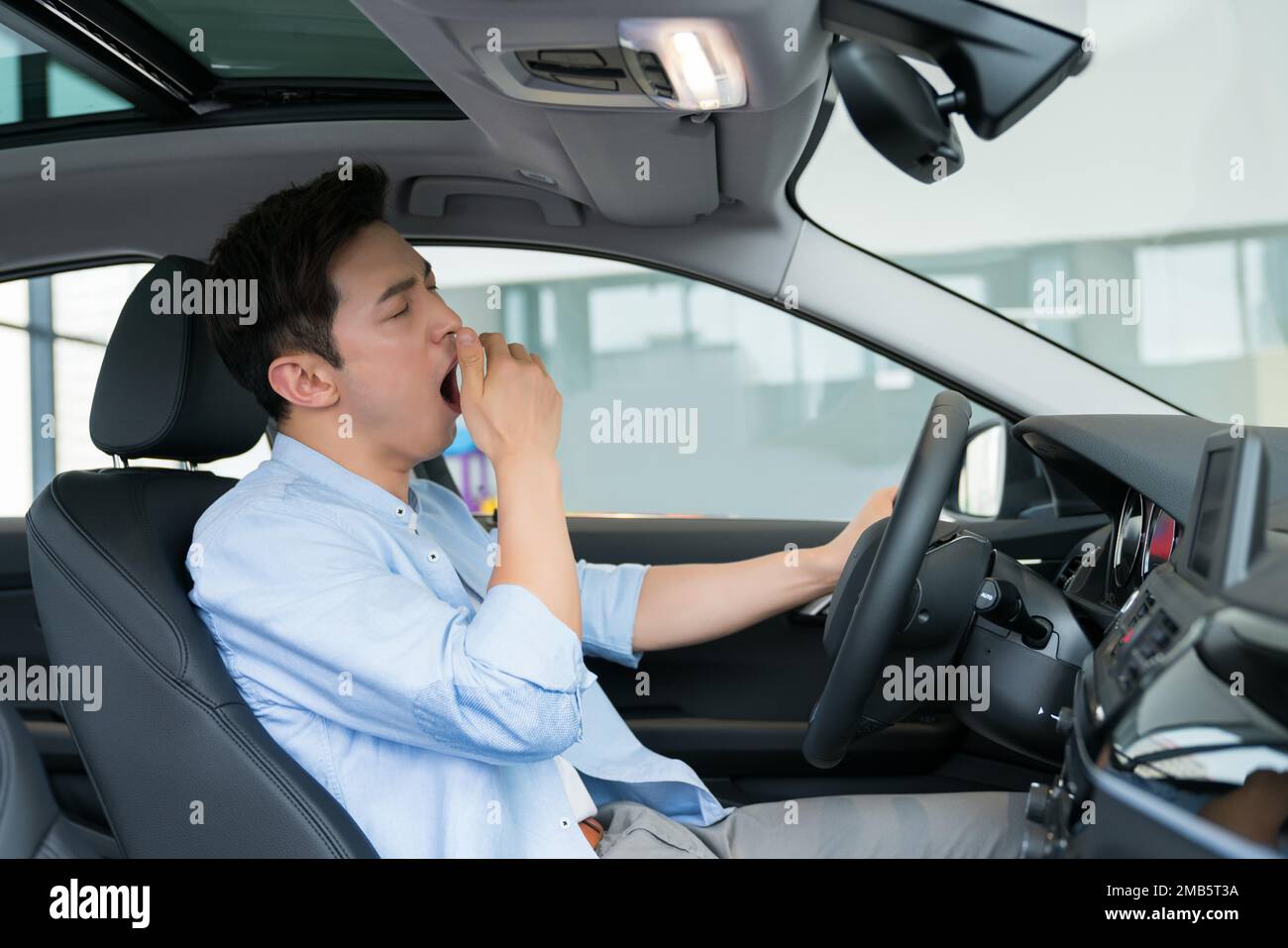Young chinese man driving car hi-res stock photography and images - Alamy