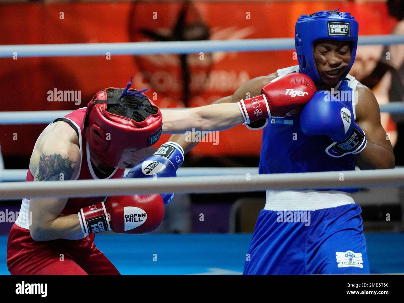 Valentina Bustamante of Chile, left, punches Angie Valdes of Colombia ...