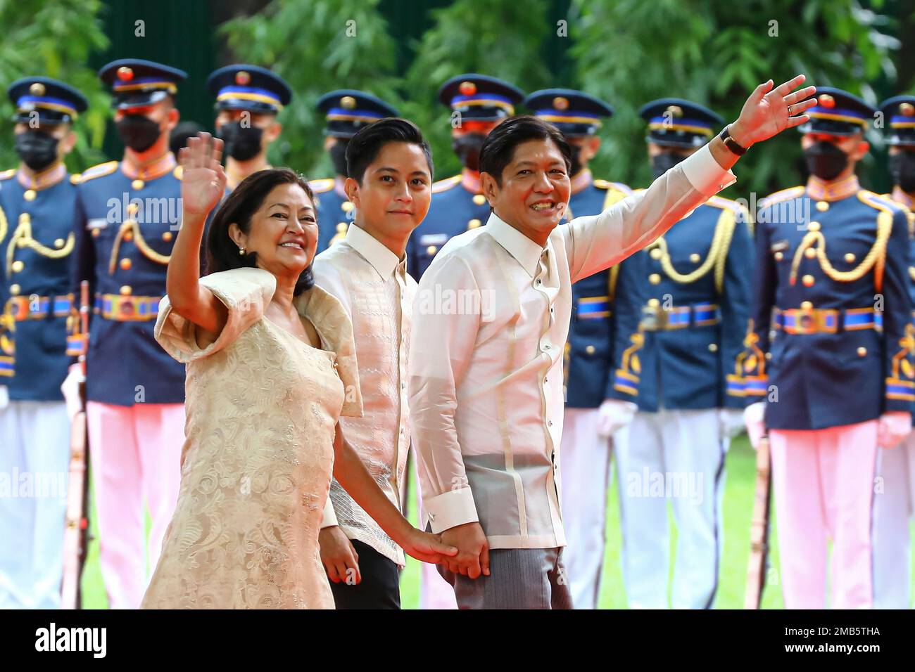 Philippine President Ferdinand Marcos Jr., right, waves beside wife ...
