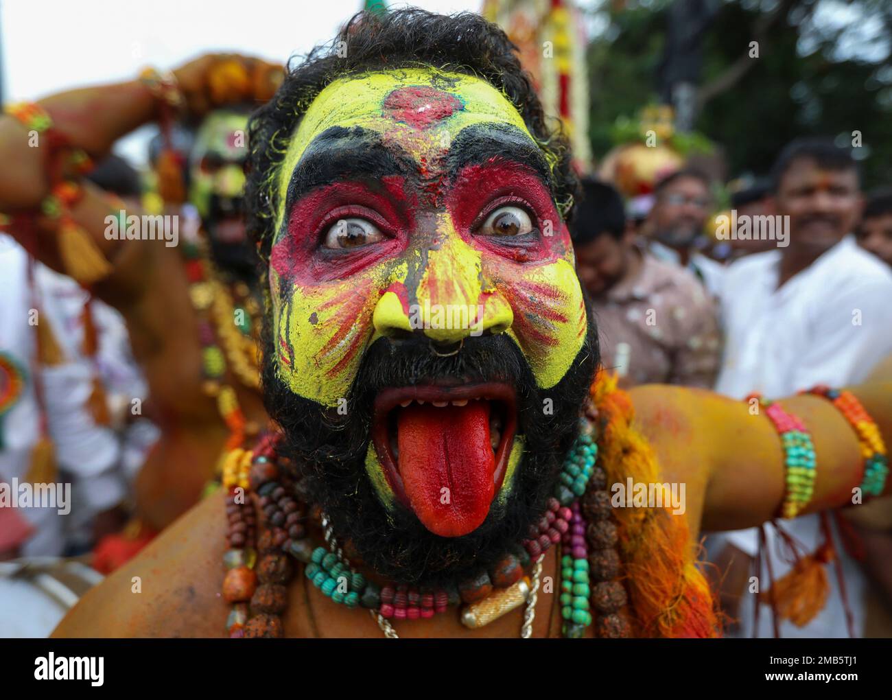 A man dressed as Pothuraju, a mythical character, performs rituals ...