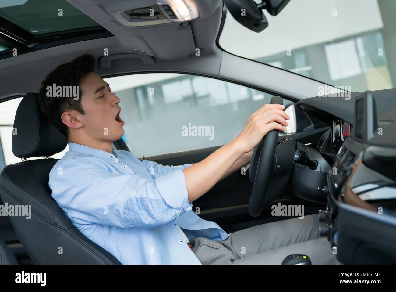 Young chinese man driving car hi-res stock photography and images - Alamy