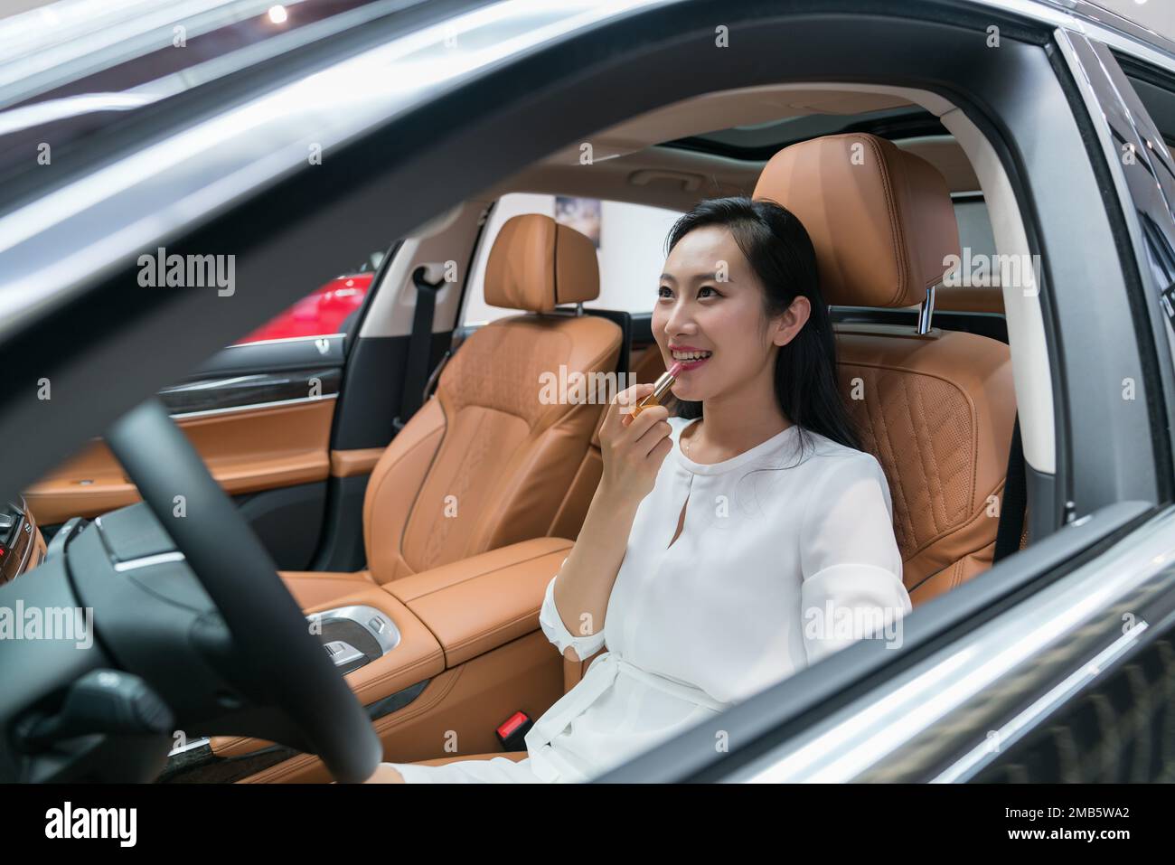 The young woman makeup in the car Stock Photo - Alamy