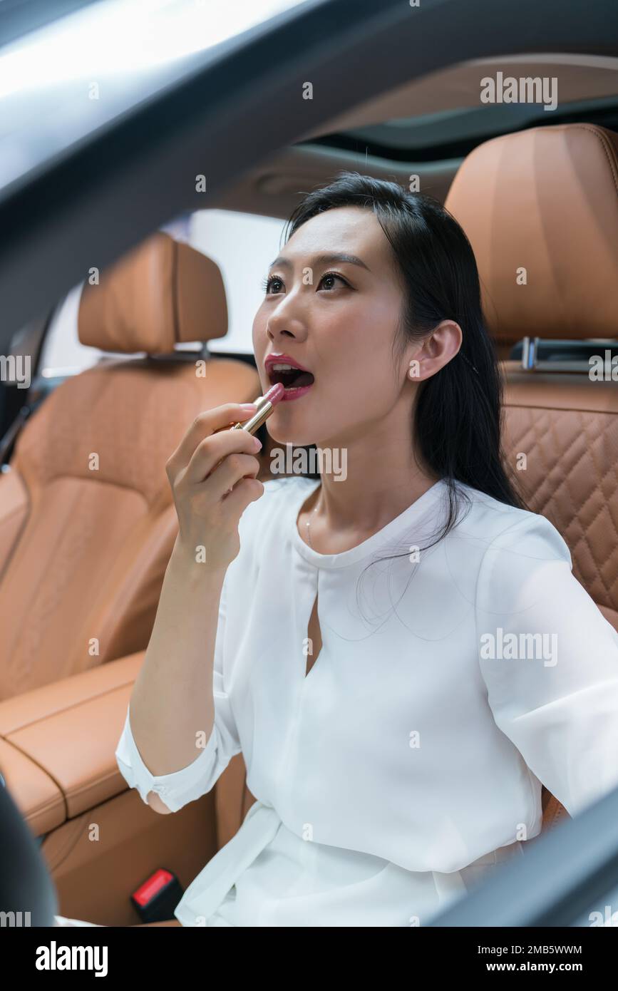 The young woman makeup in the car Stock Photo - Alamy