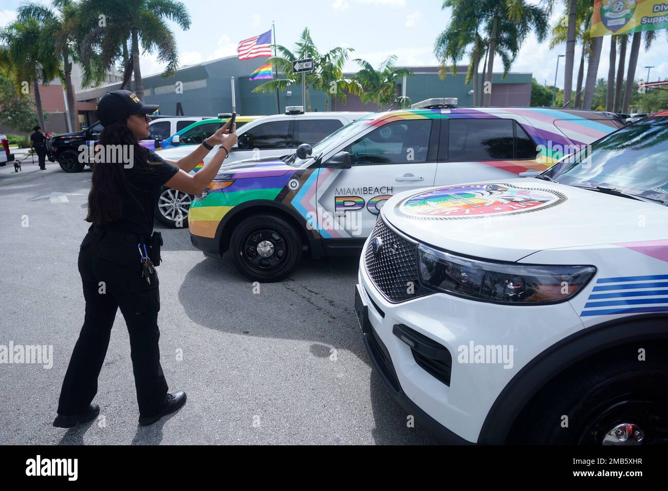 North Miami Police officer Melani Andrade takes photos of police cars ...