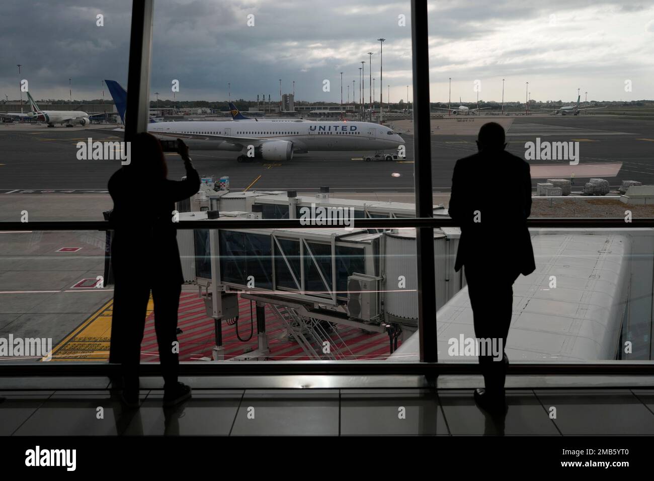 FILE - People look at a United Airlines flight leaving for Newark, NJ ...