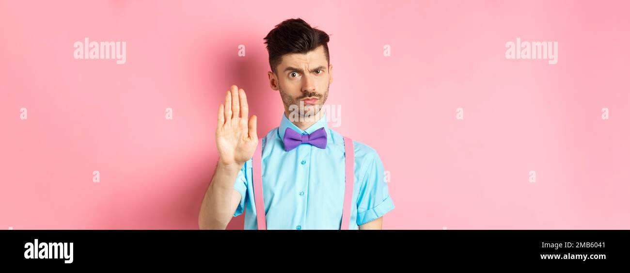 Serious-looking man prohibit something bad, stretch out hand to stop ...