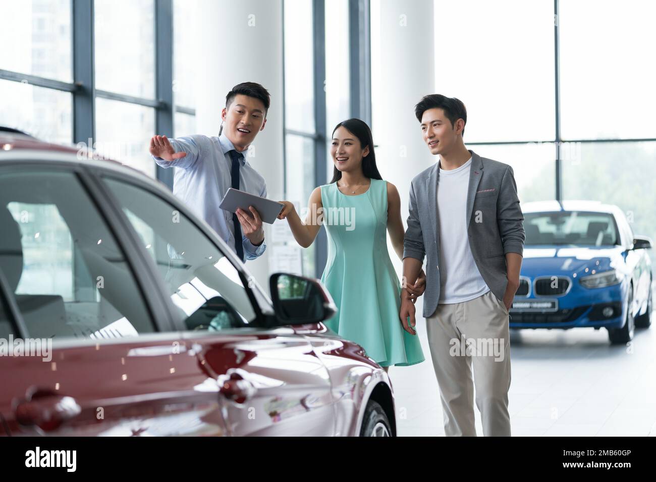 A young couple of choose and buy cars Stock Photo - Alamy
