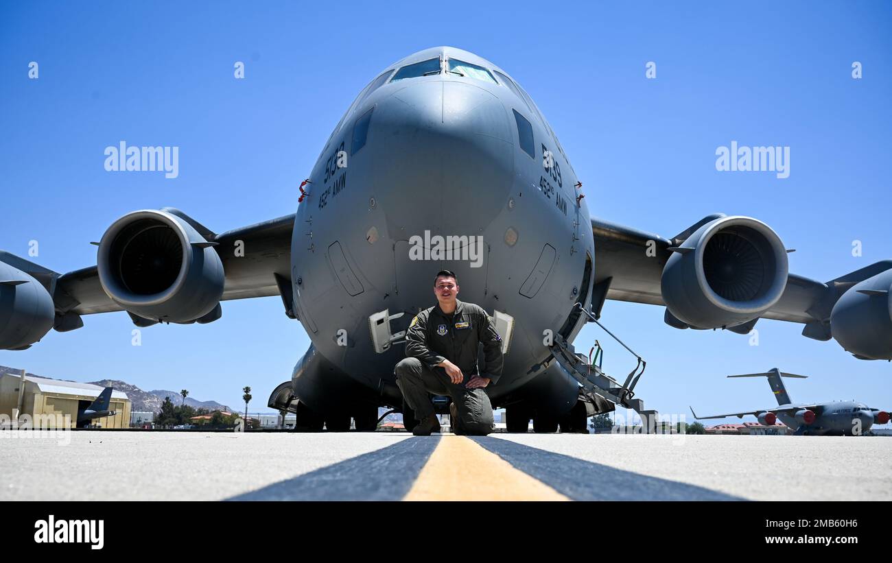 U.S. Air Force SrA. Casey Bernatz, 729th Airlift Squadron crouches for a photo in front of the C ...