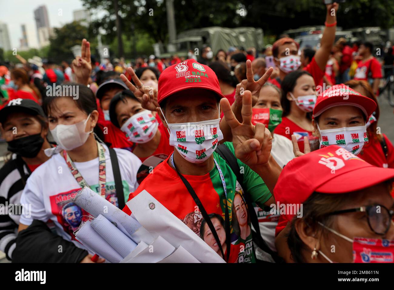 Supporters flash the "V" sign meaning "Victory!" as they gather for the ...