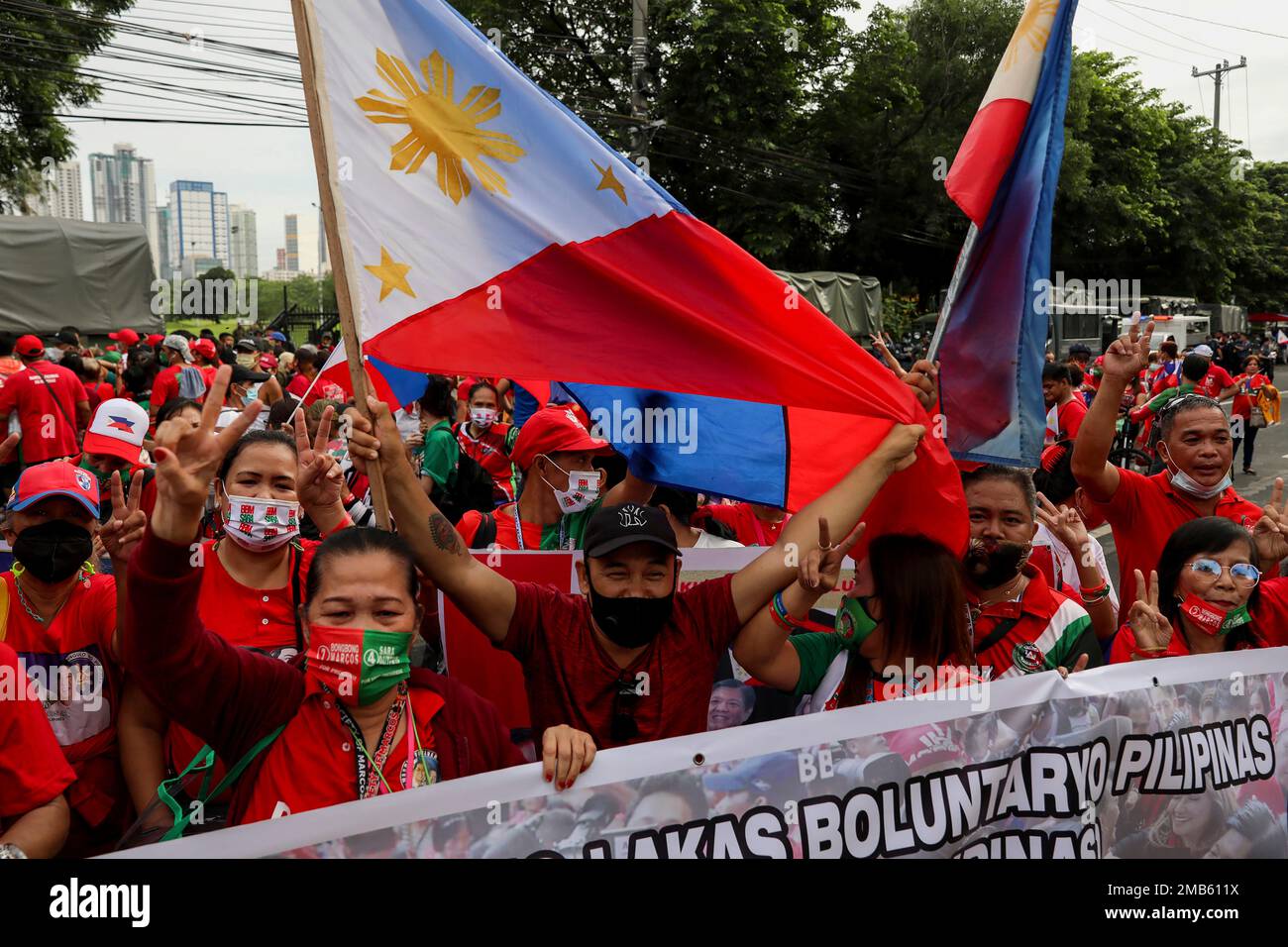 Supporters wave Philippine flags and flash the "V" sign meaning ...