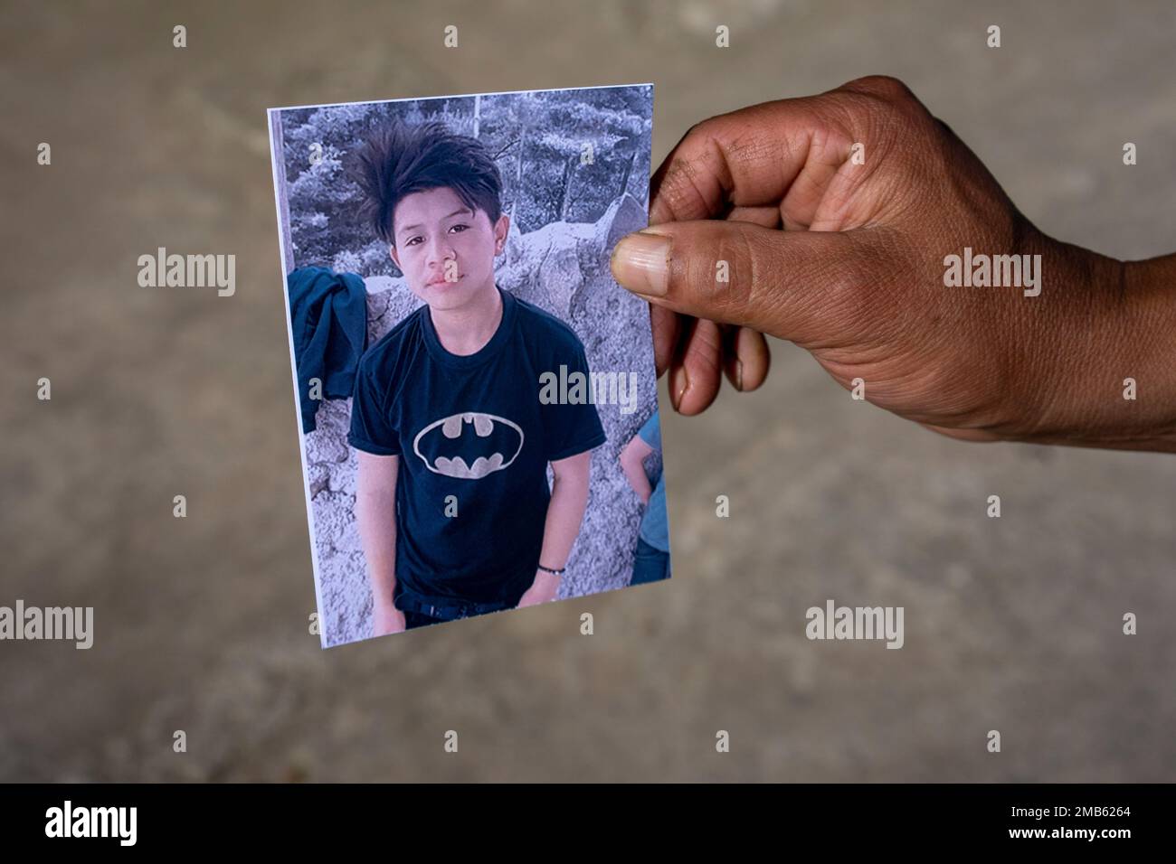 A man shows a portrait of Wilmer Tulul, in Tzucubal, Guatemala ...