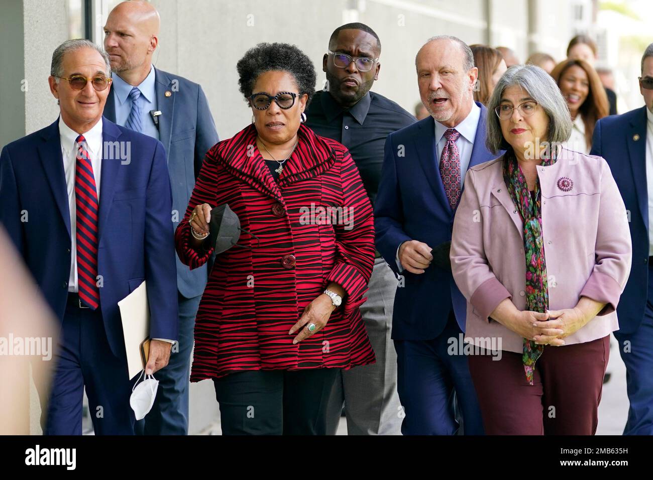 Housing and Urban Development (HUD) Secretary Marcia Fudge, second from left, walks with Judge ...