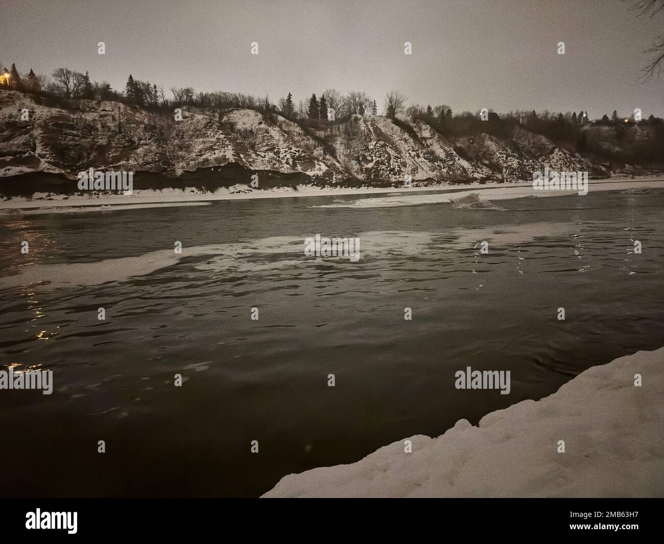 A river captured from the snowy coast at sunrise Stock Photo - Alamy