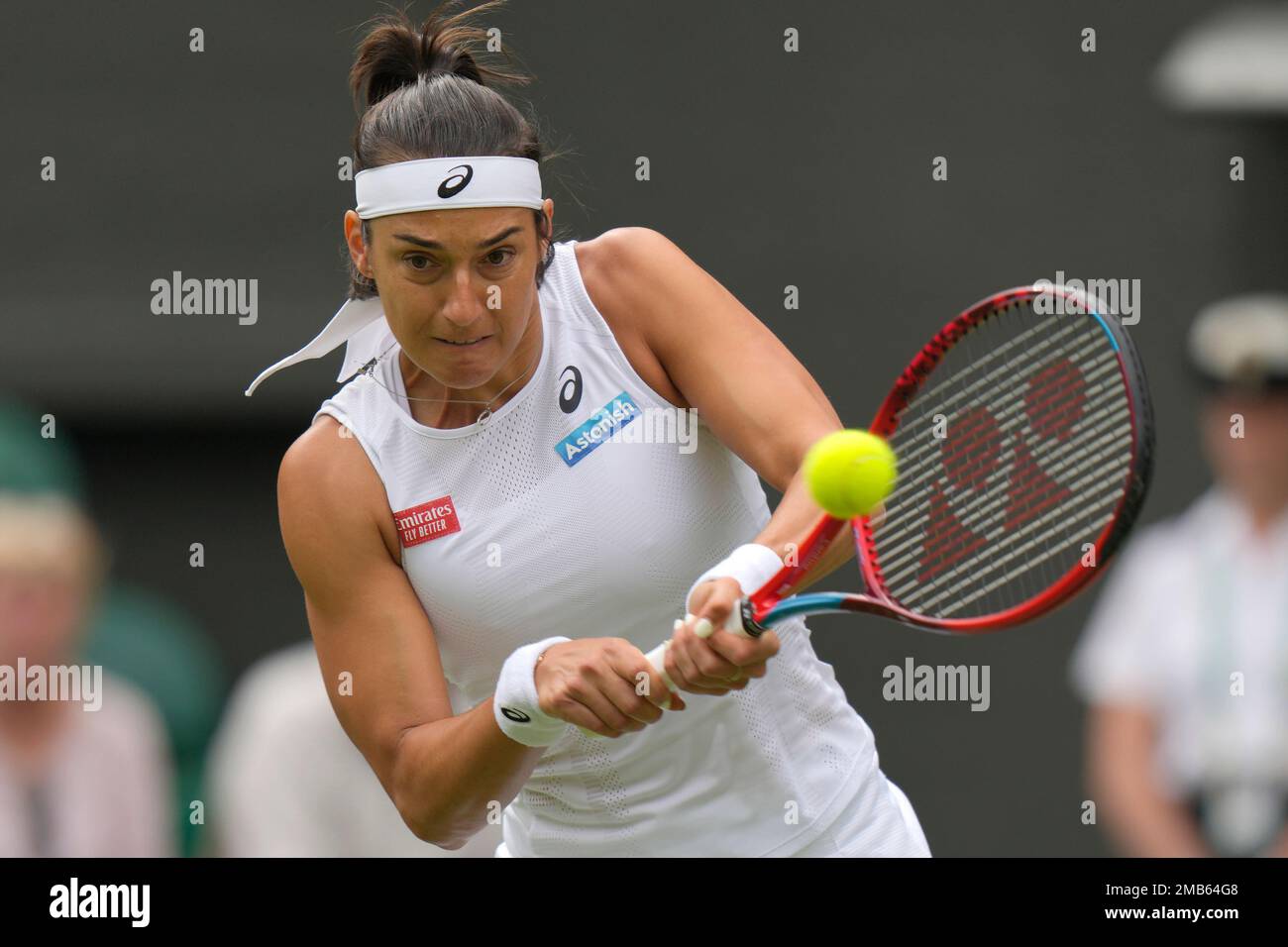 France's Caroline Garcia returns the ball to Britain's Emma Raducanu ...