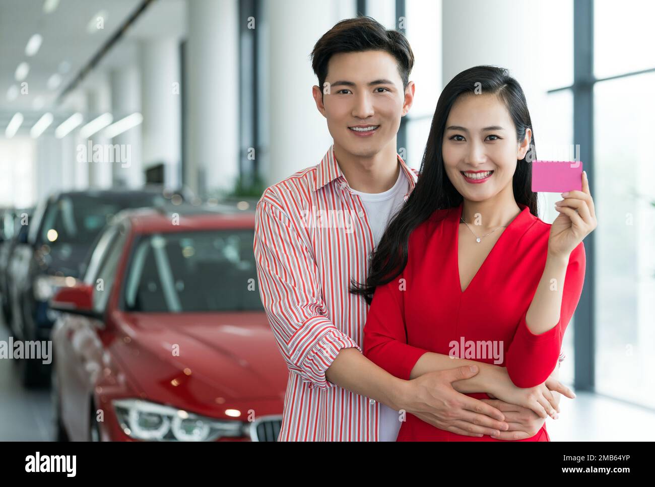 A young couple of choose and buy cars Stock Photo - Alamy