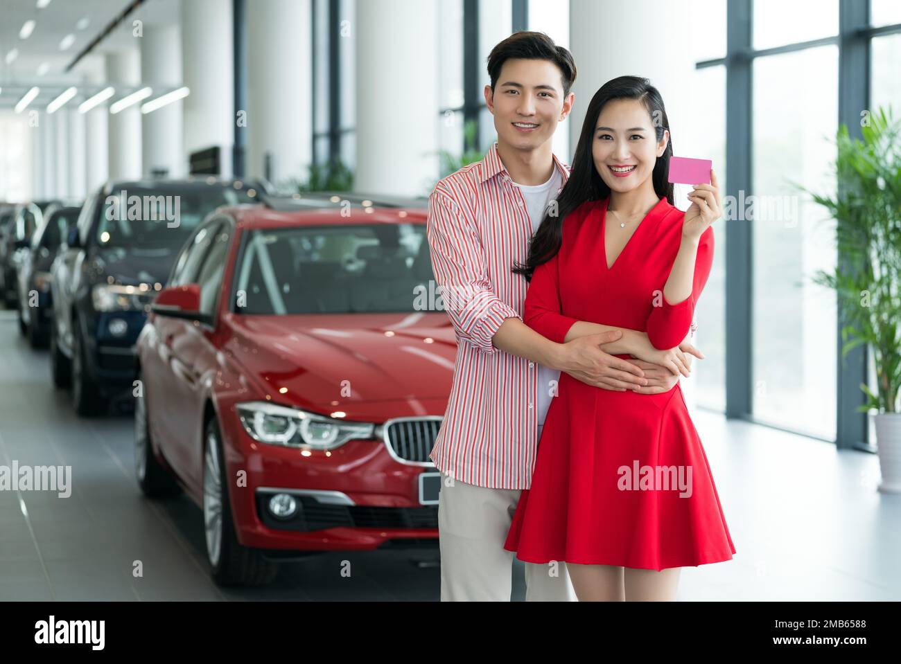 A young couple of choose and buy cars Stock Photo - Alamy