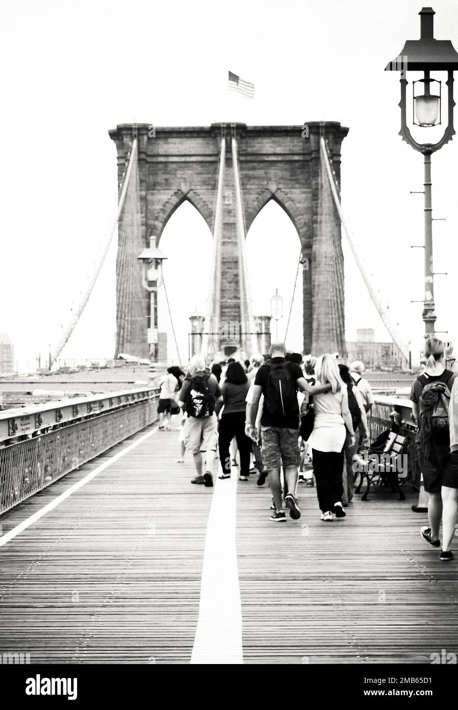 Black and white portrait of Brooklyn Bridge with people taken from the ...