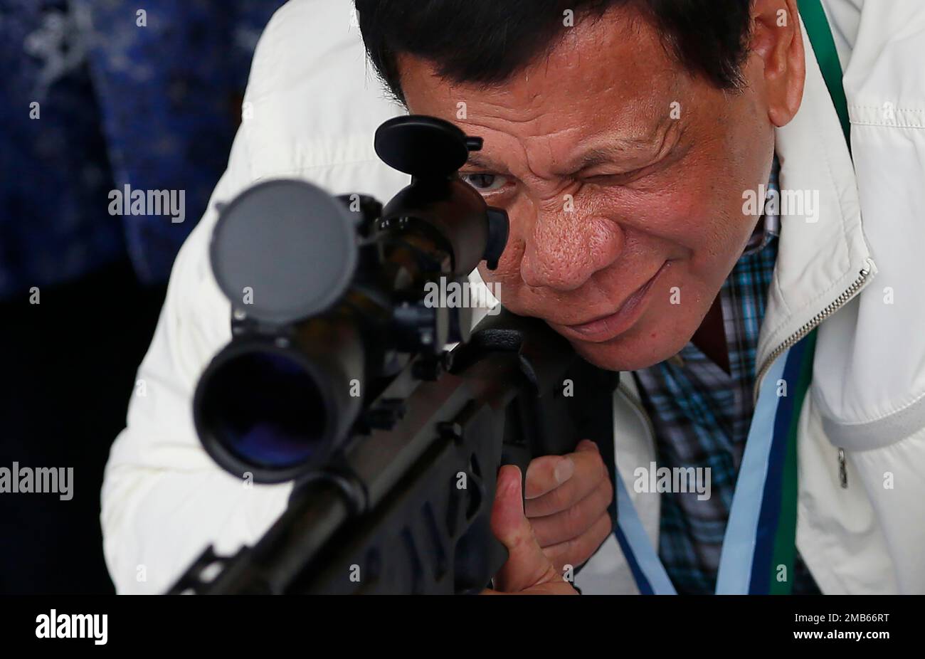 FILE - Philippine President Rodrigo Duterte checks the scope of a ...